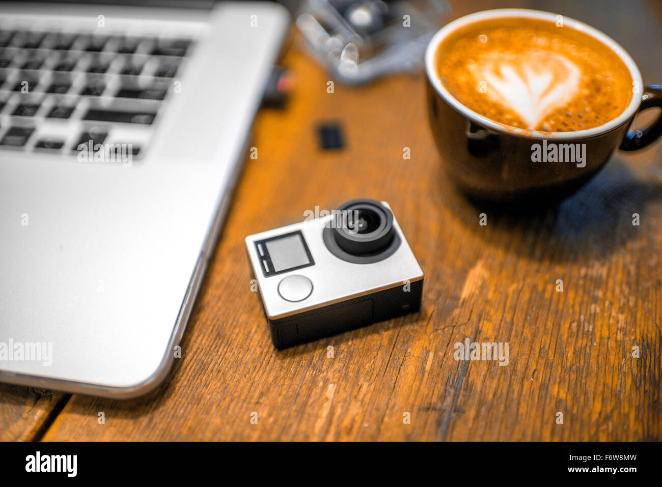 Small action video camera with coffe cup and laptop on the wooden table ...