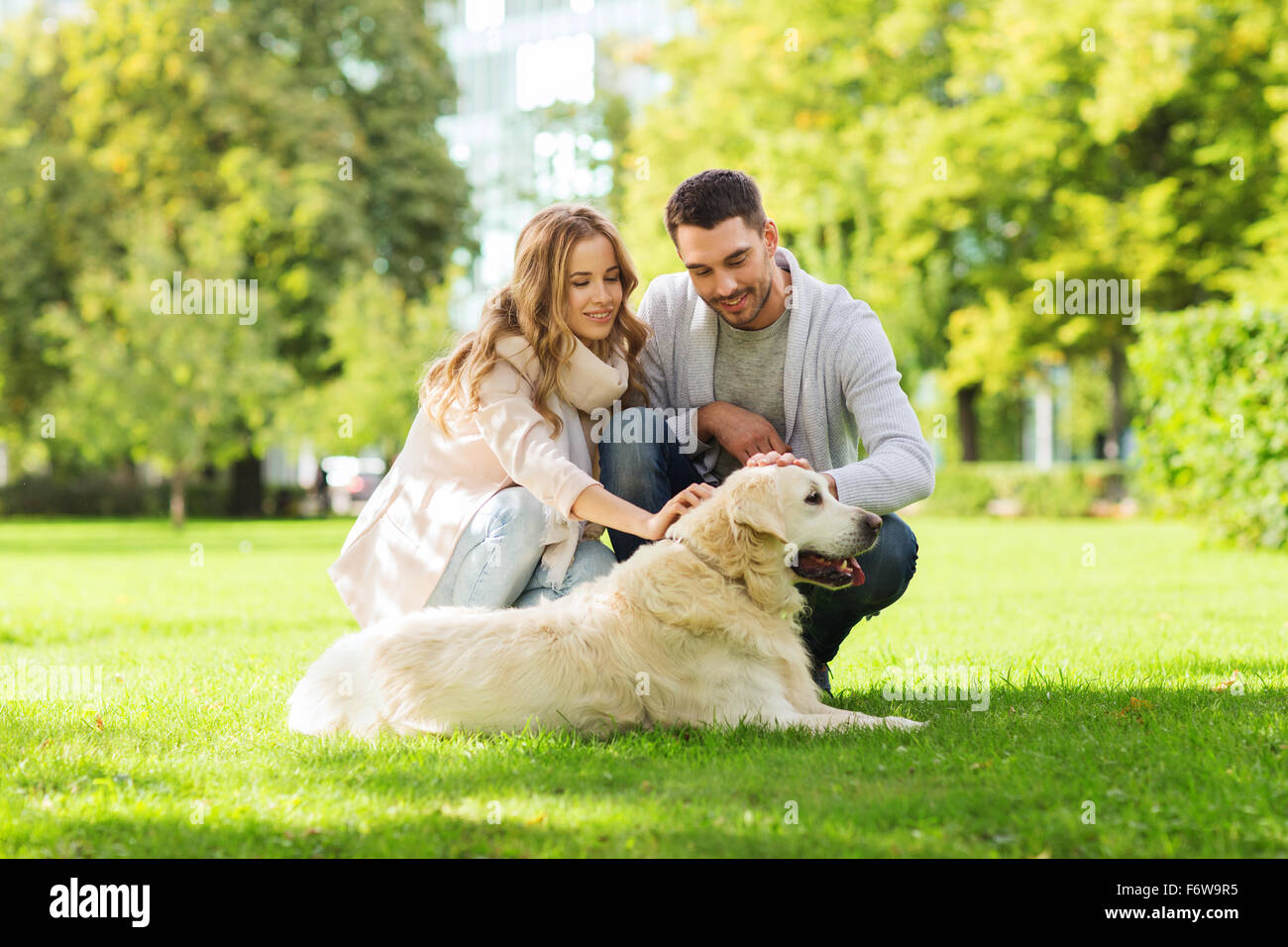happy couple with labrador dog walking in city Stock Photo - Alamy