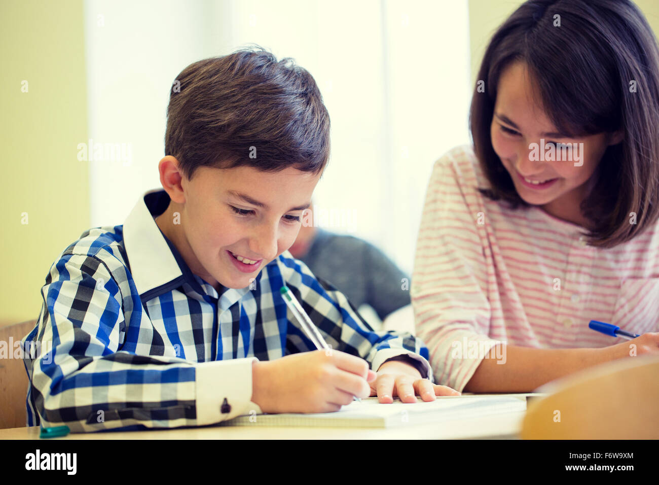group of school kids writing test in classroom Stock Photo - Alamy
