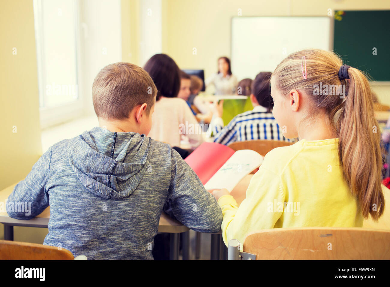 group of school kids writing test in classroom Stock Photo - Alamy