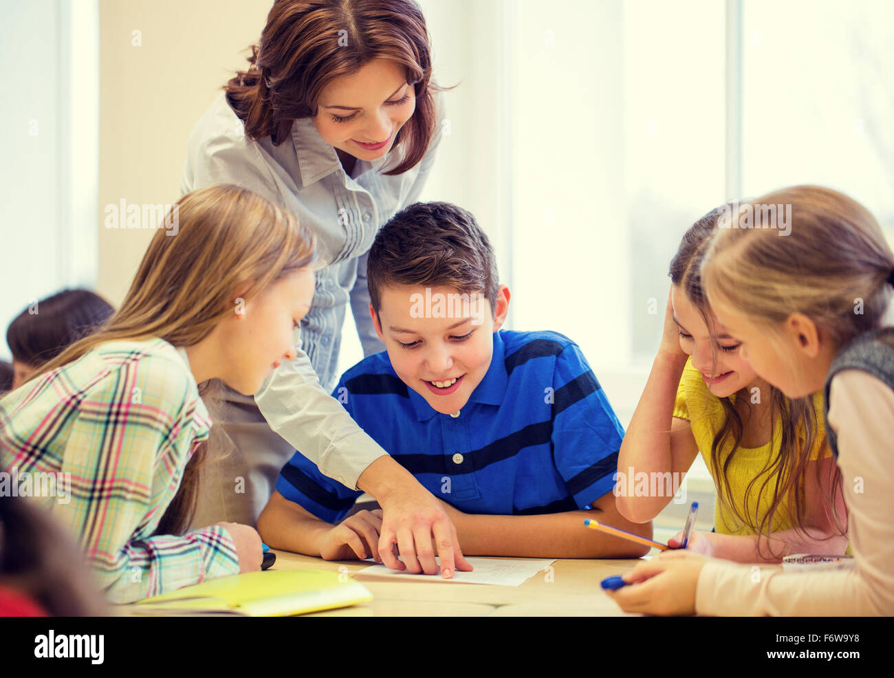 group of school kids writing test in classroom Stock Photo - Alamy