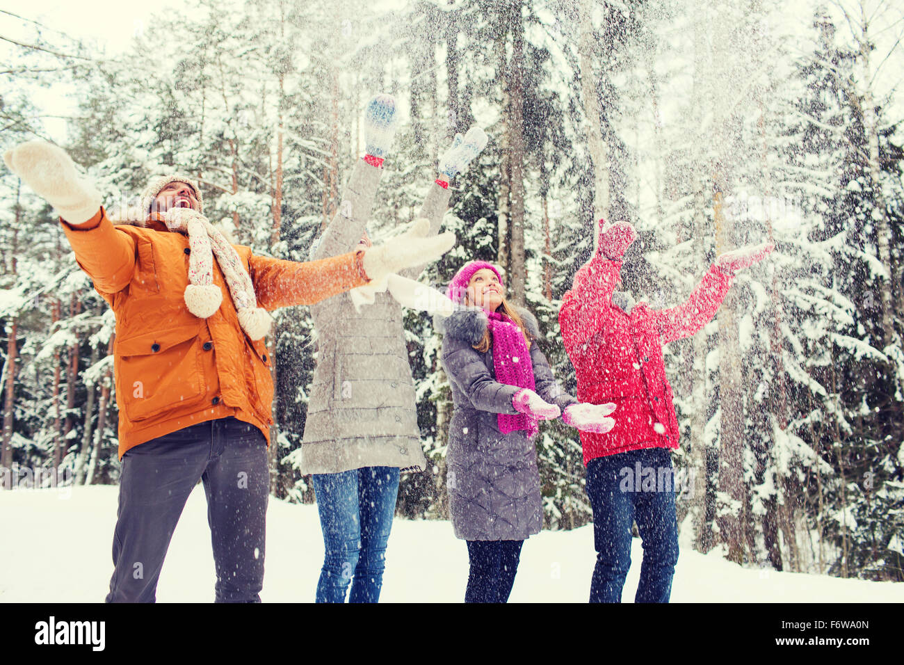 group of smiling men and women in winter forest Stock Photo - Alamy