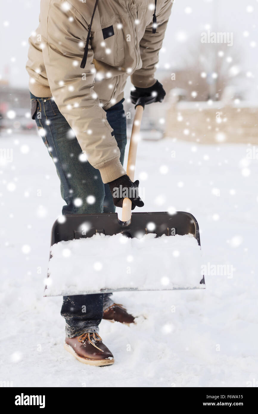 closeup of man digging snow with shovel Stock Photo - Alamy