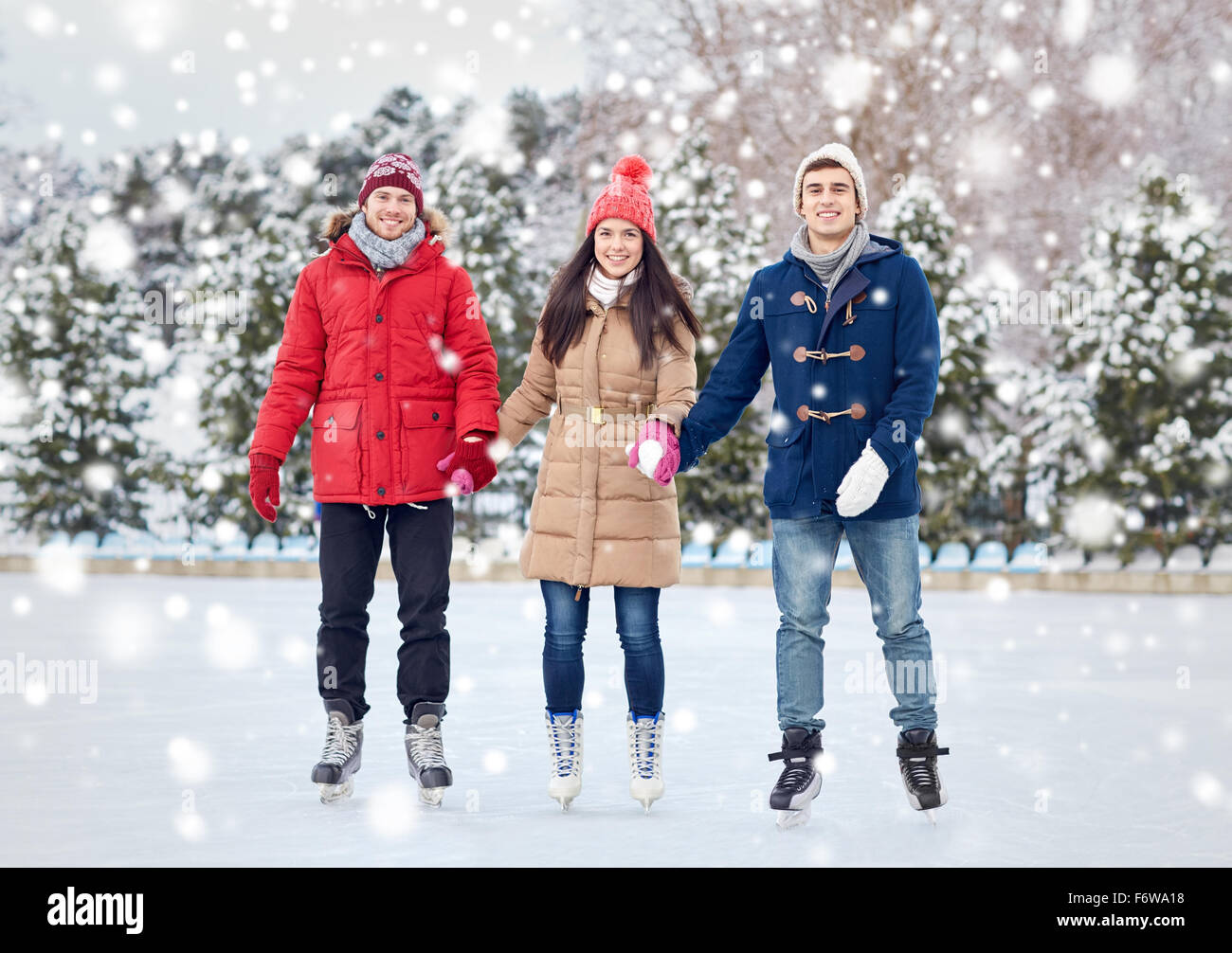 happy friends ice skating on rink outdoors Stock Photo - Alamy