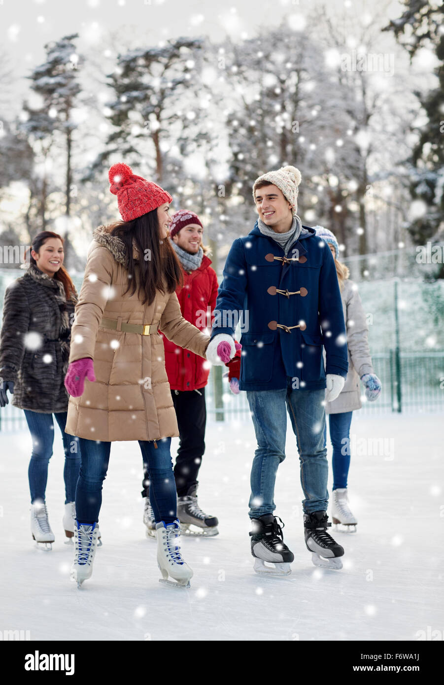 happy friends ice skating on rink outdoors Stock Photo - Alamy