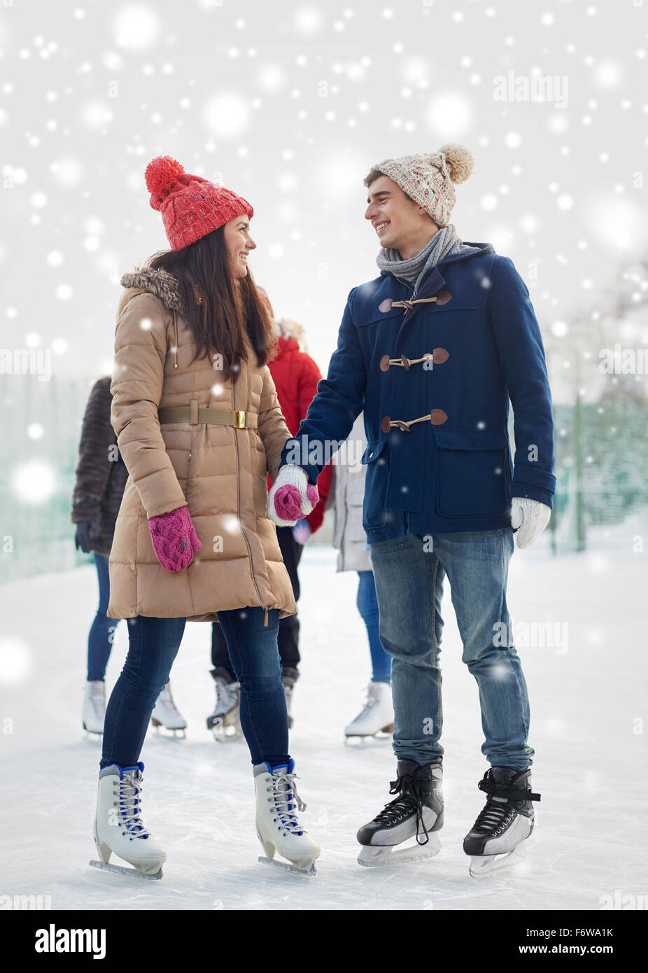 happy friends ice skating on rink outdoors Stock Photo - Alamy