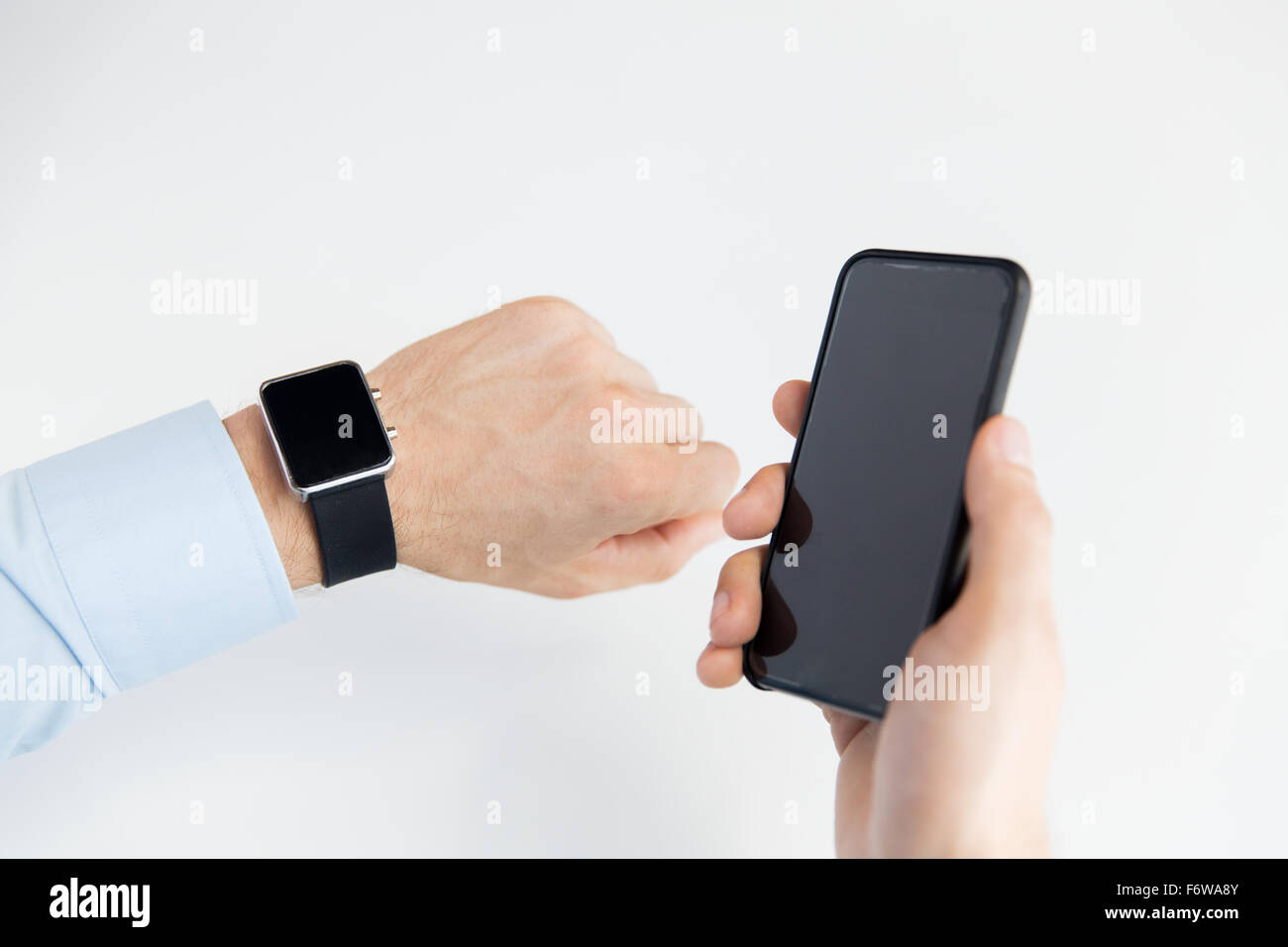 close up of hands with smart phone and watch Stock Photo - Alamy