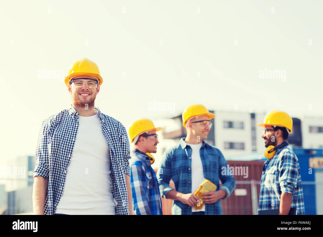 group of smiling builders in hardhats outdoors Stock Photo - Alamy