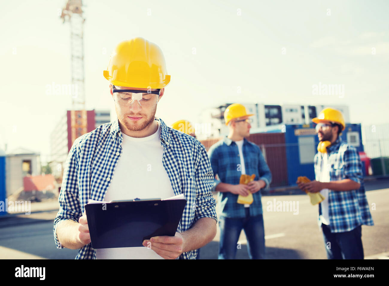 group of builders in hardhats outdoors Stock Photo - Alamy