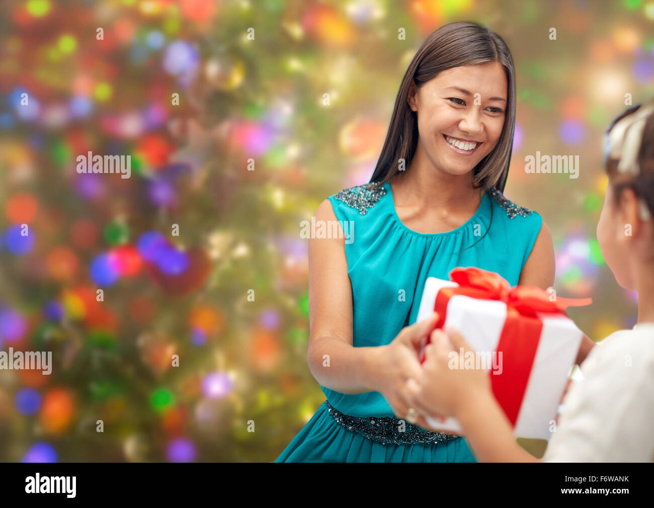 happy mother giving christmas present to her child Stock Photo - Alamy