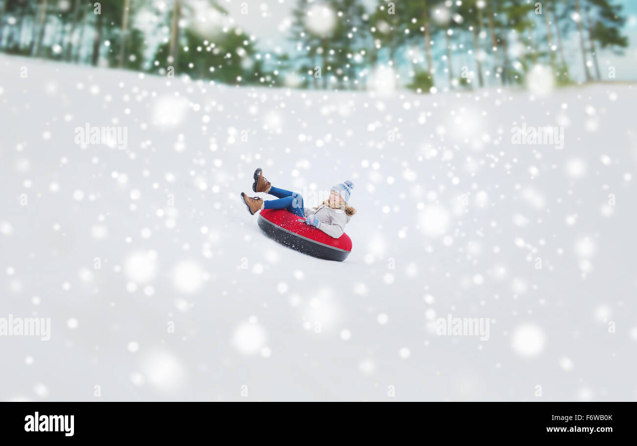happy teenage girl sliding down on snow tube Stock Photo - Alamy
