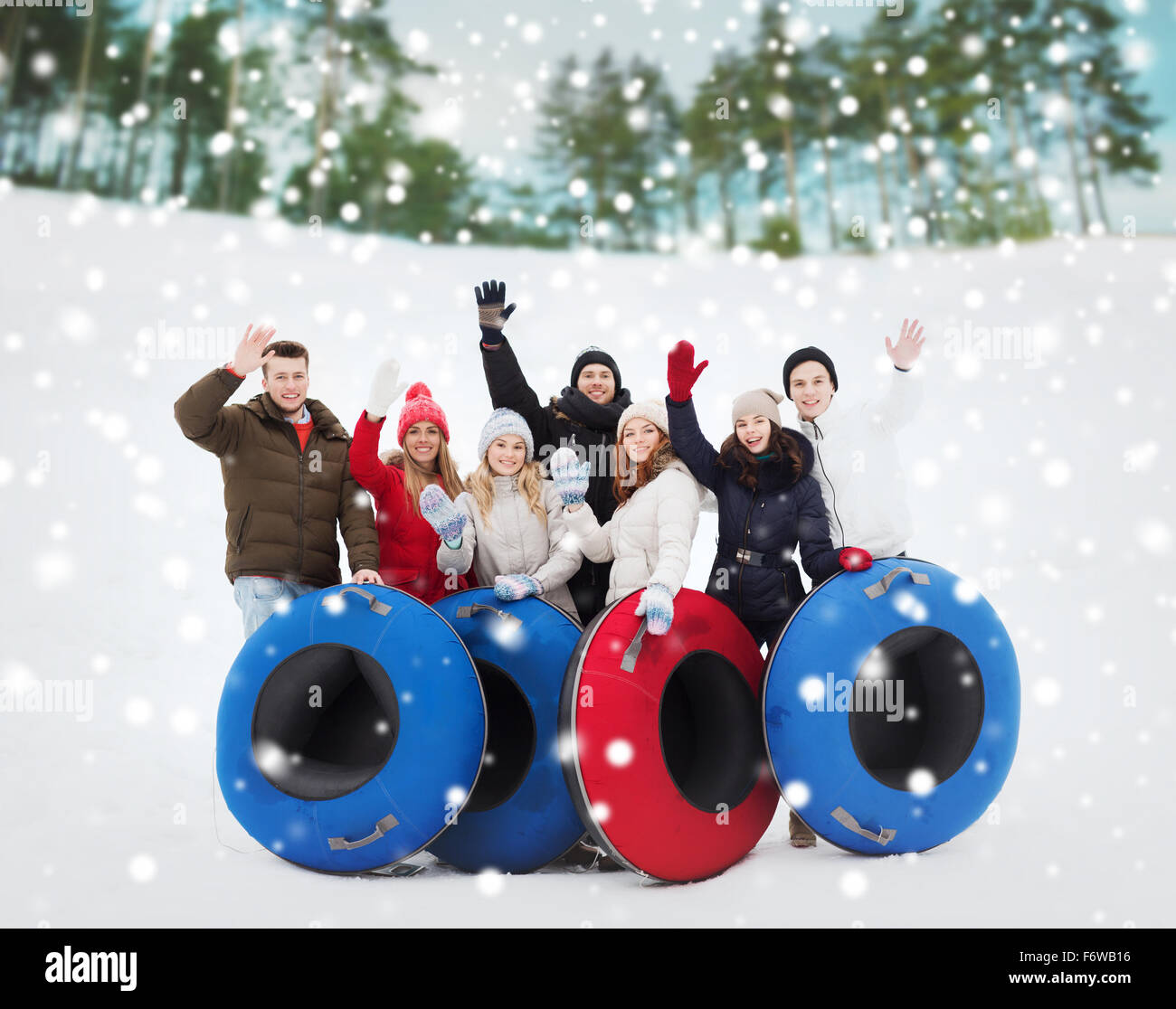 group of smiling friends with snow tubes Stock Photo - Alamy