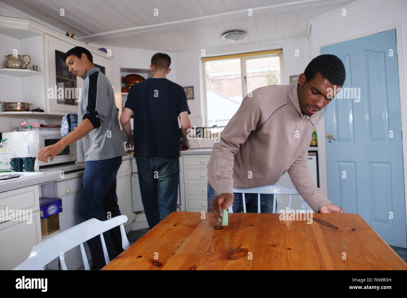 Youths cleaning the kitchen Stock Photo - Alamy