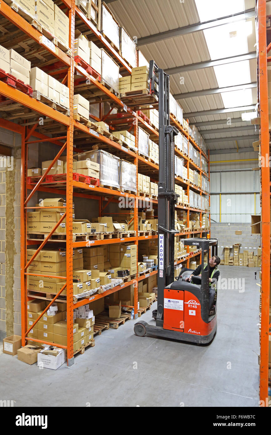 A compact, high-reach, fork-lift truck removes goods on a pallet from ...