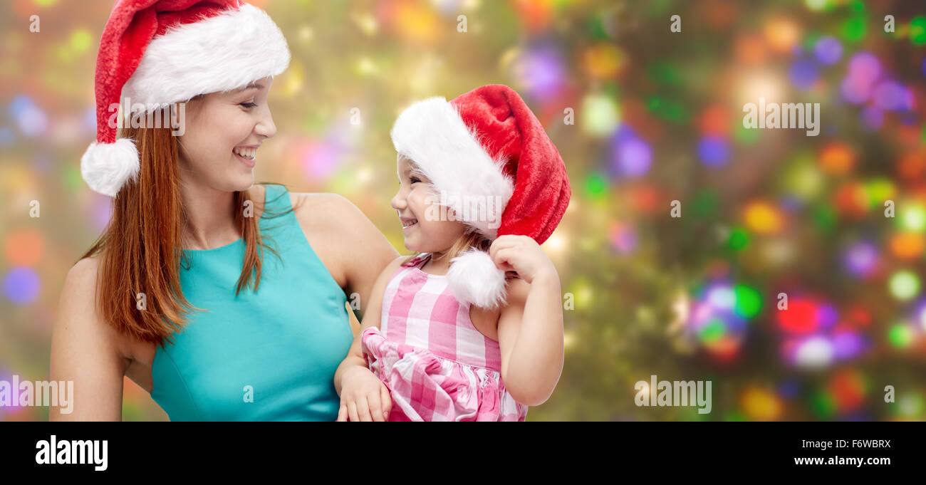 happy mother and little girl in santa hats Stock Photo - Alamy