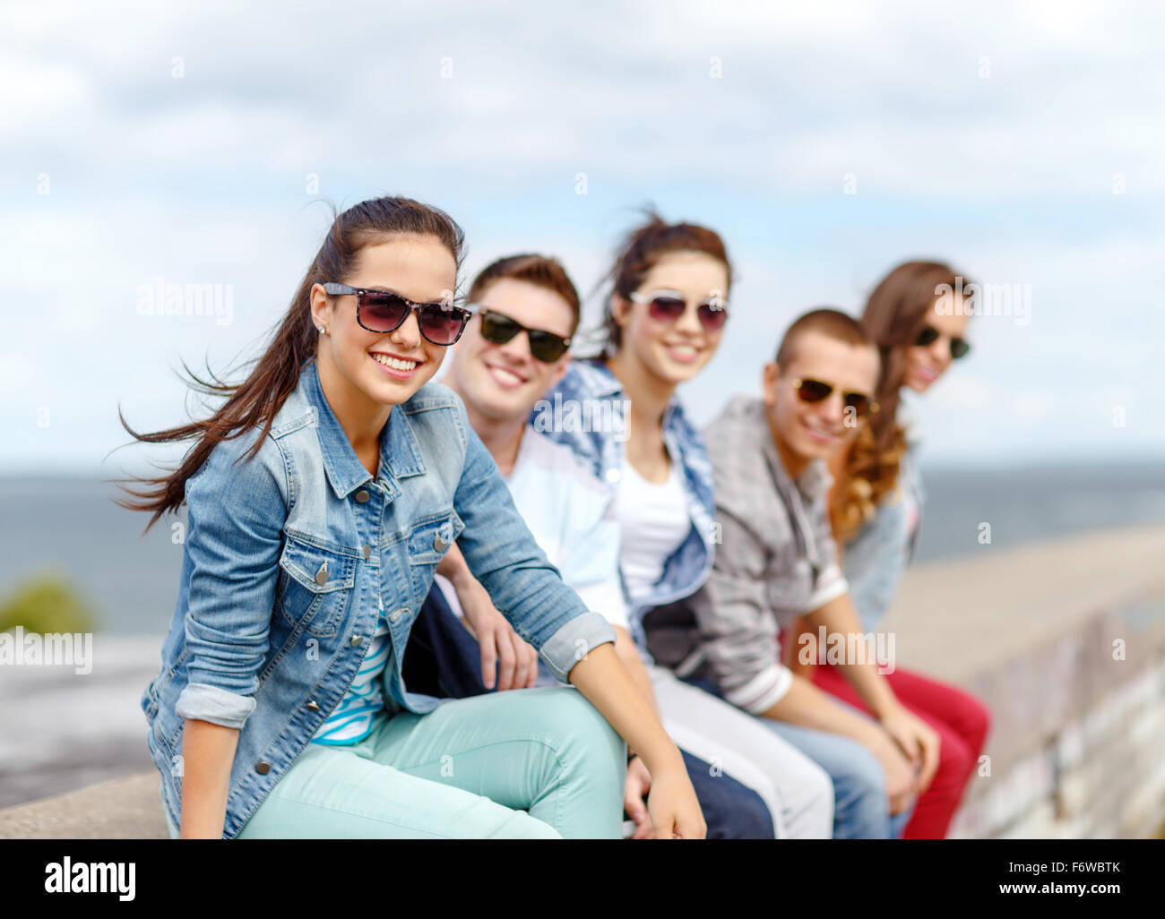 smiling teenage girl hanging out with friends Stock Photo - Alamy