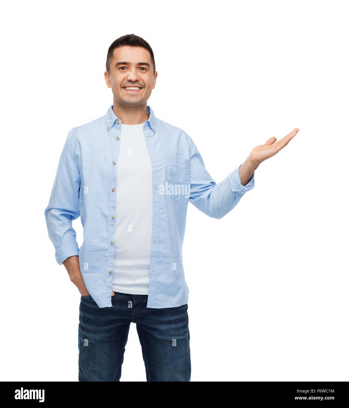 smiling man showing something on empty palm Stock Photo - Alamy