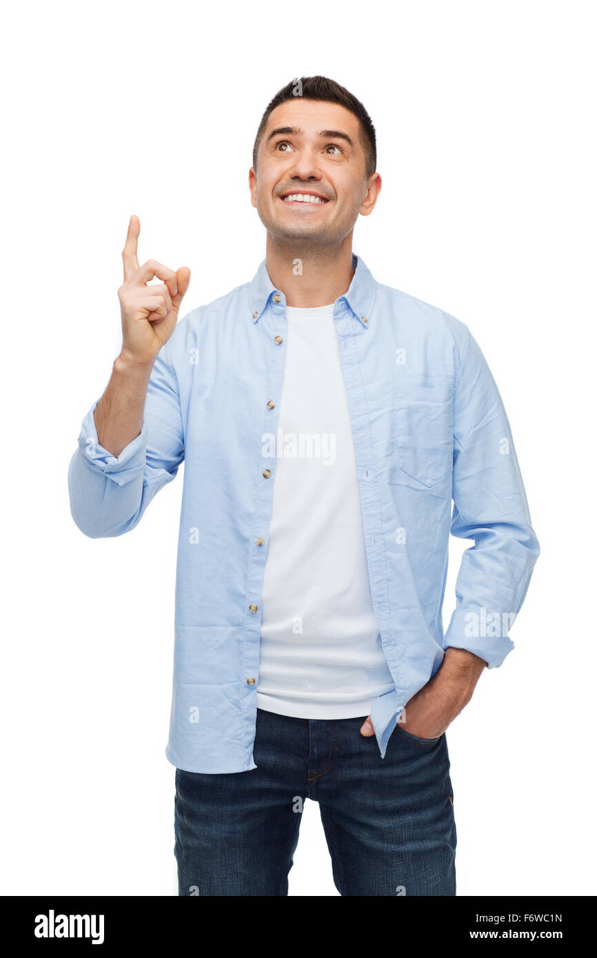 smiling man pointing finger up Stock Photo - Alamy