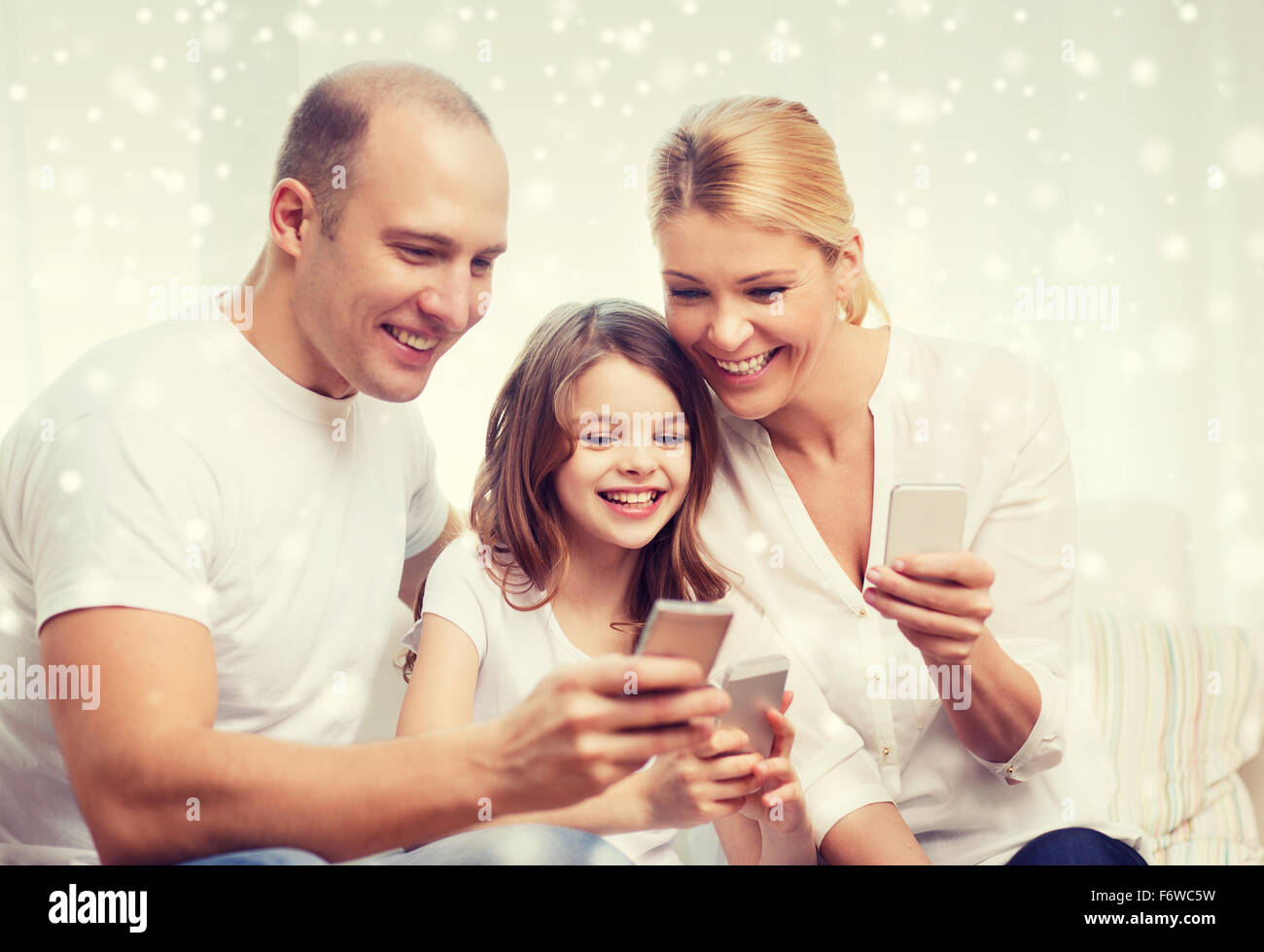happy family with smartphones at home Stock Photo - Alamy