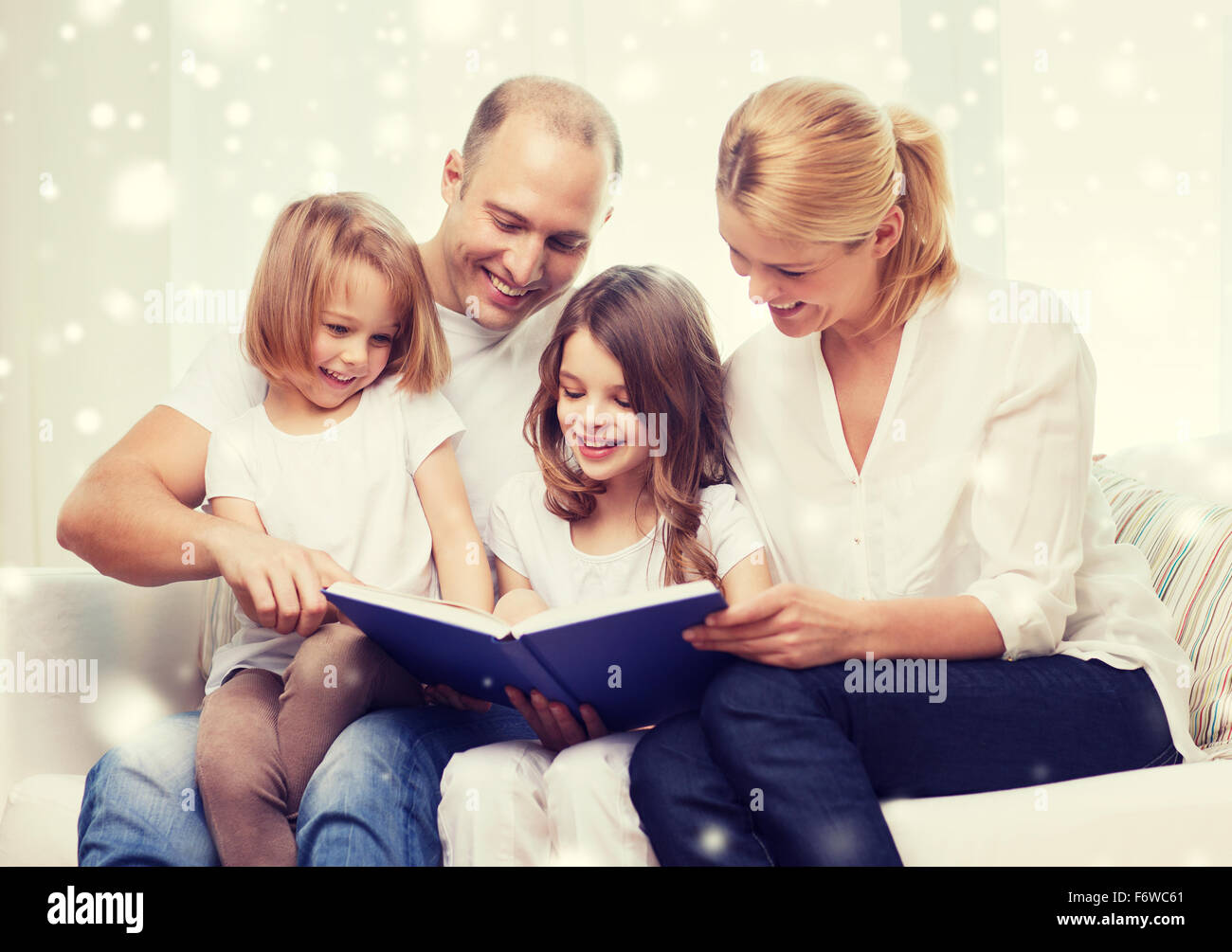happy family with book at home Stock Photo - Alamy