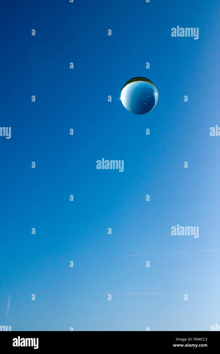 single crystal ball and bubbles on blue sky Stock Photo - Alamy