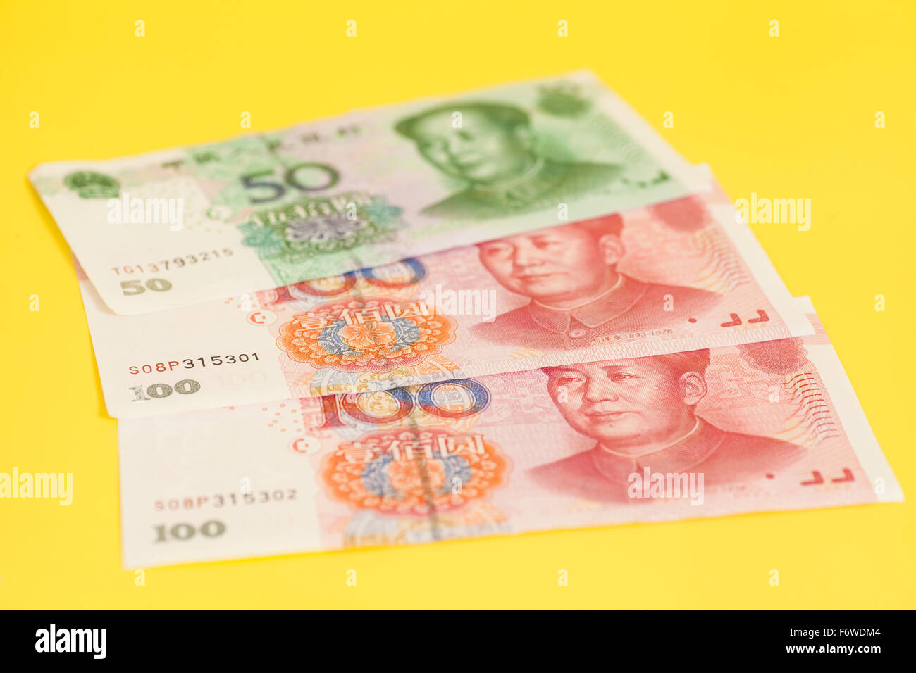 Chinese yuan banknotes on yellow background Stock Photo - Alamy