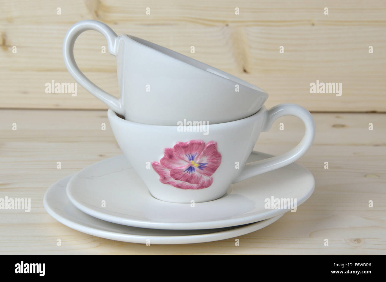 Porcelain cups with pink flower and saucers Stock Photo - Alamy