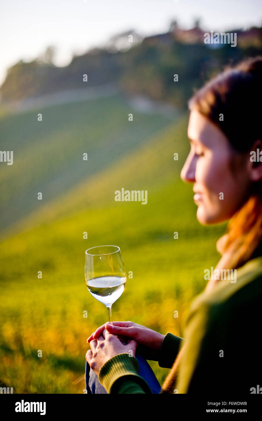 Young woman holding a glass of white wine, Spielfeld, Styria, Austria ...