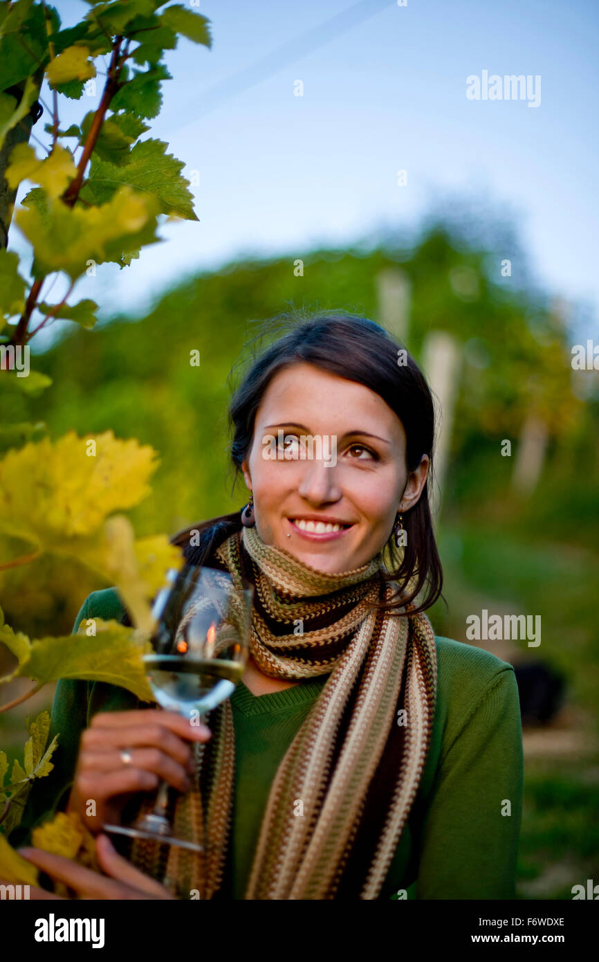 Young woman holding a glass of white wine, Spielfeld, Styria, Austria ...
