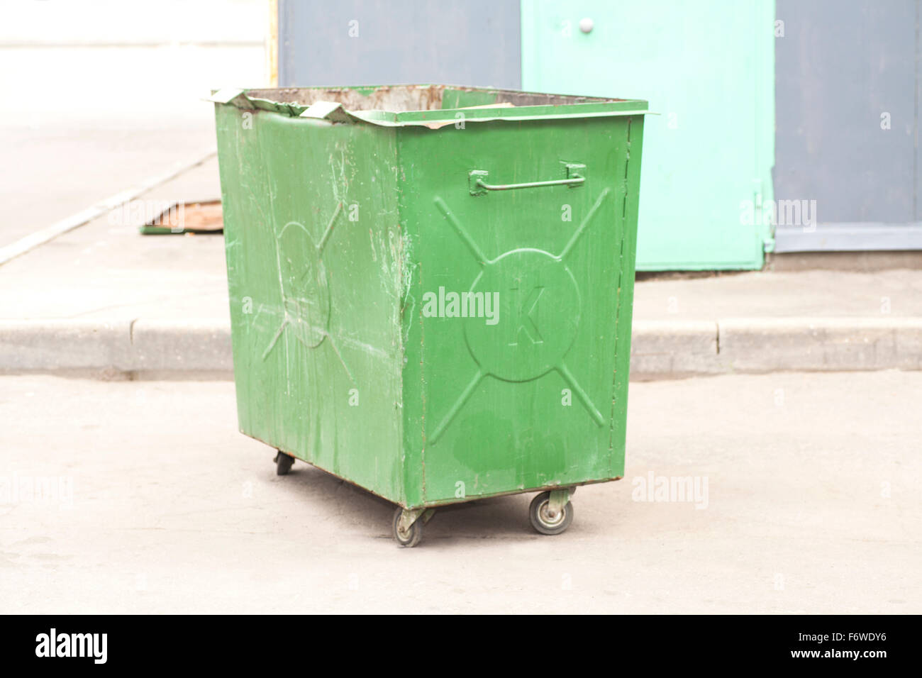 Green recycling container on street of city Stock Photo - Alamy