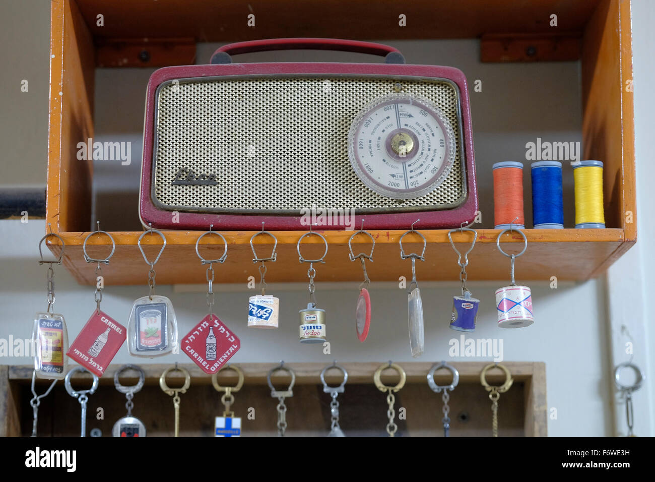 Display of old key chains and a vintage radio transistor inside the ...