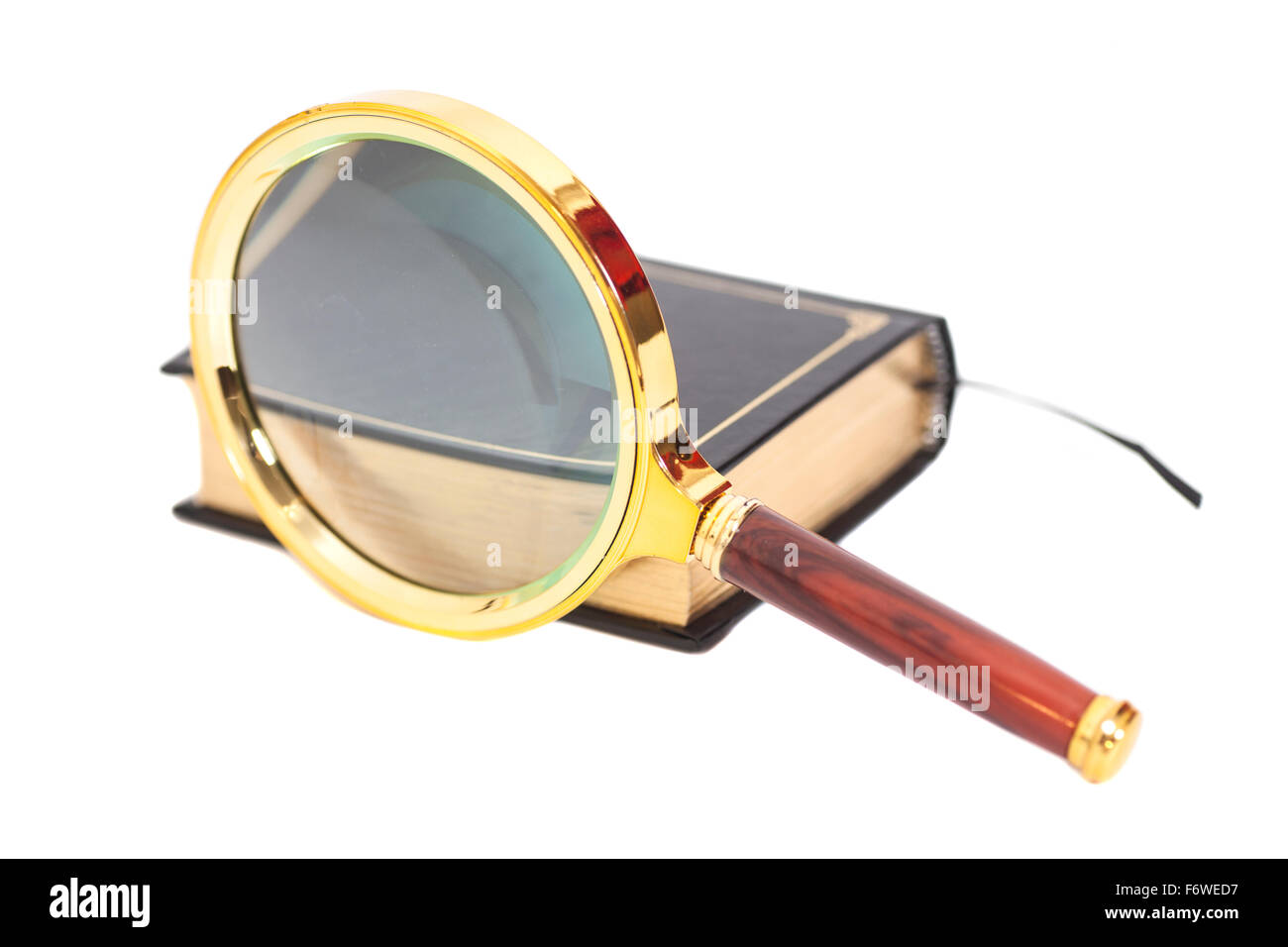 Book with magnifying glass over white background Stock Photo - Alamy