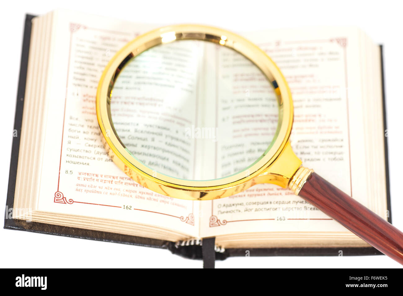 Open Book with magnifying glass over white background Stock Photo - Alamy