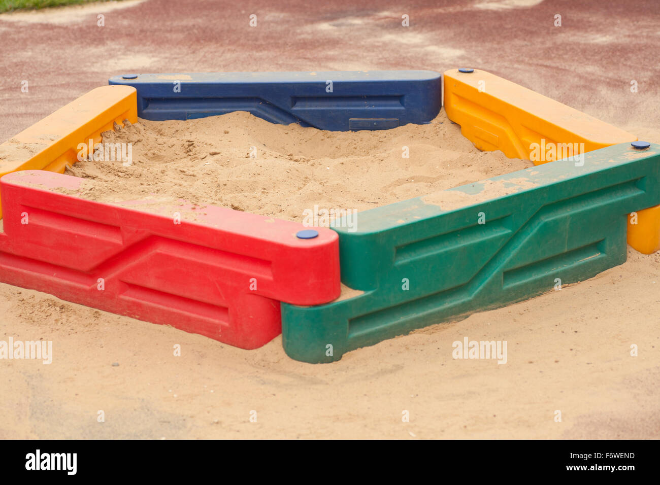 Children's sandbox with yellow sand Stock Photo - Alamy