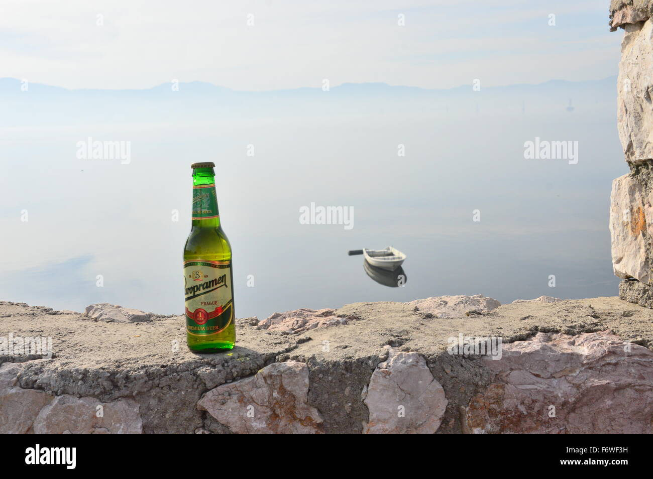 bottle brand beer of the backgrounds big lake and boat Stock Photo - Alamy