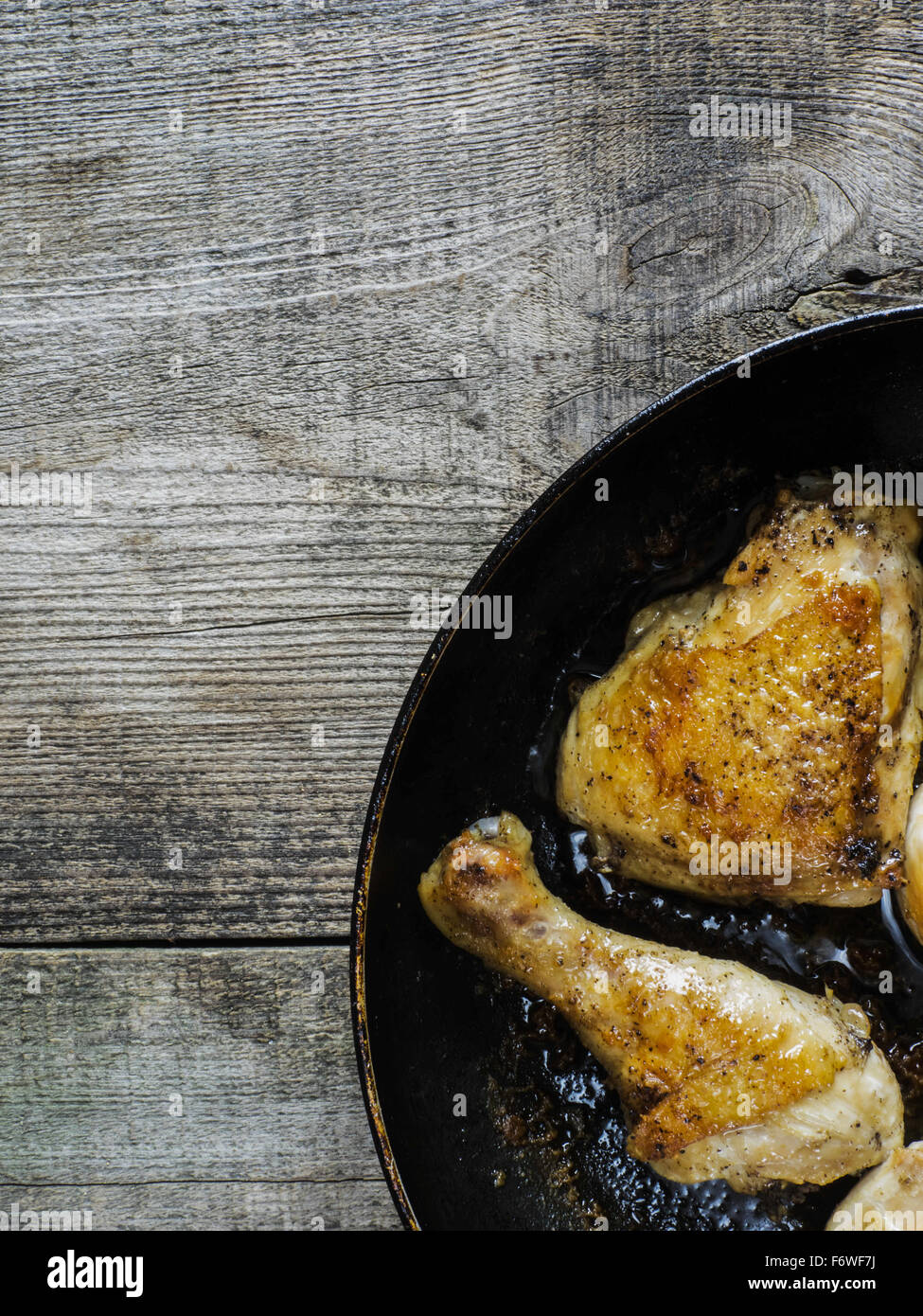 Nov. 18, 2015 - Roasted chicken thighs in a pan on old weathering ...