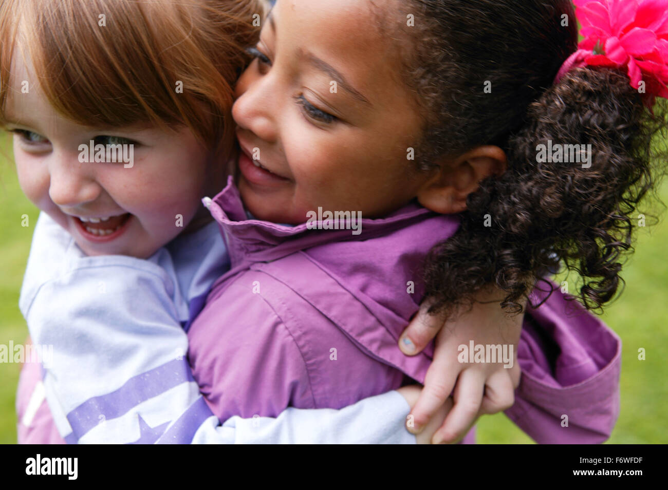 Young girls playing and hugging Stock Photo - Alamy