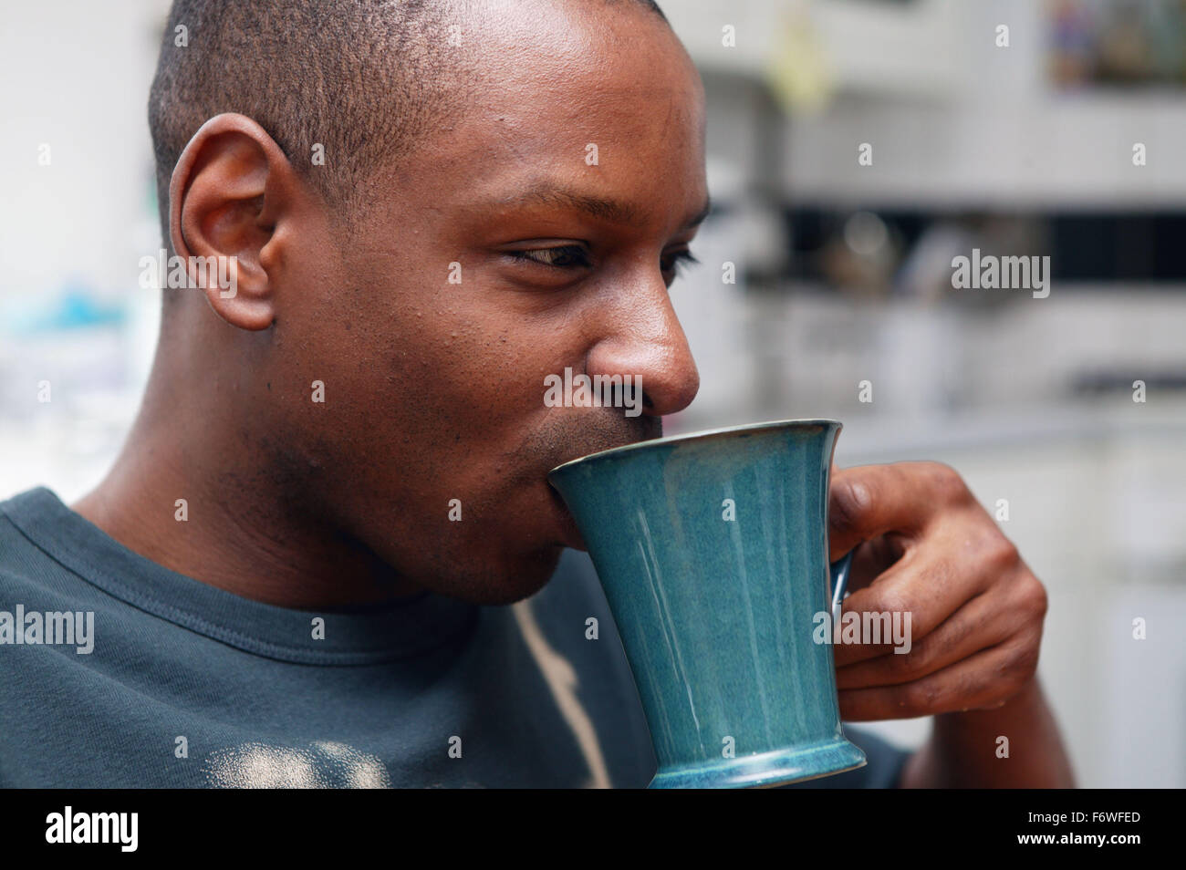 Man drinking a mug of tea Stock Photo - Alamy