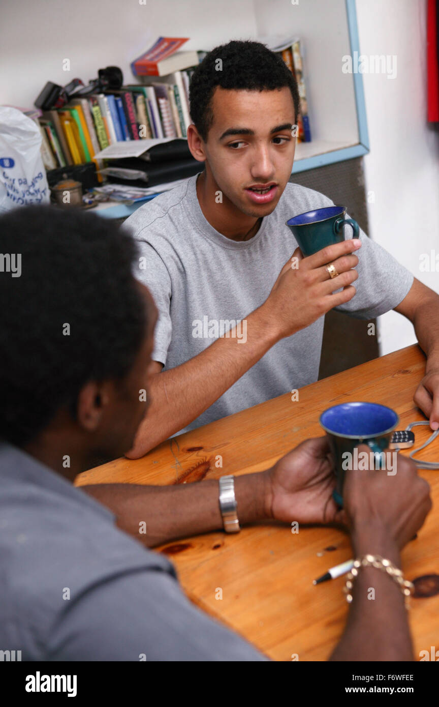 Father and son sitting drinking tea Stock Photo - Alamy
