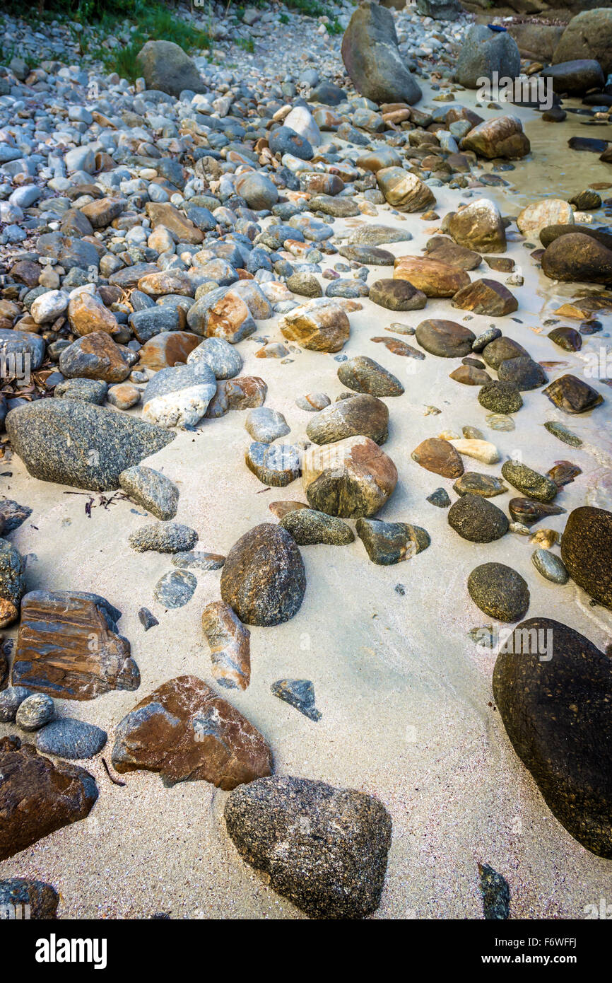 Stones on a beach sand, close up photo Stock Photo - Alamy
