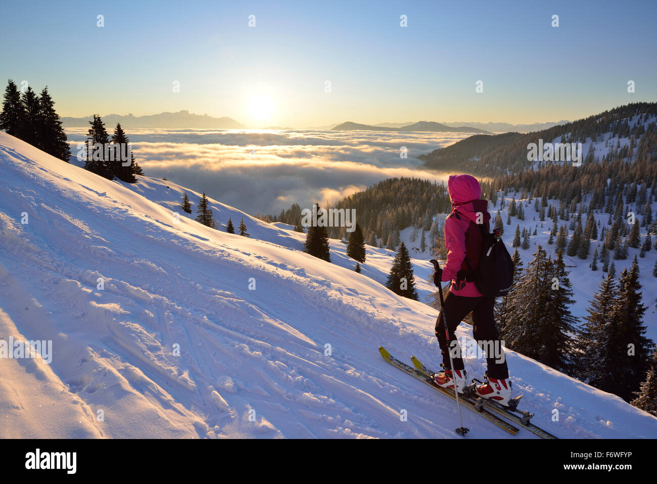 Female backcountry skier ascending to Hochkoenig, Dachstein range and ...