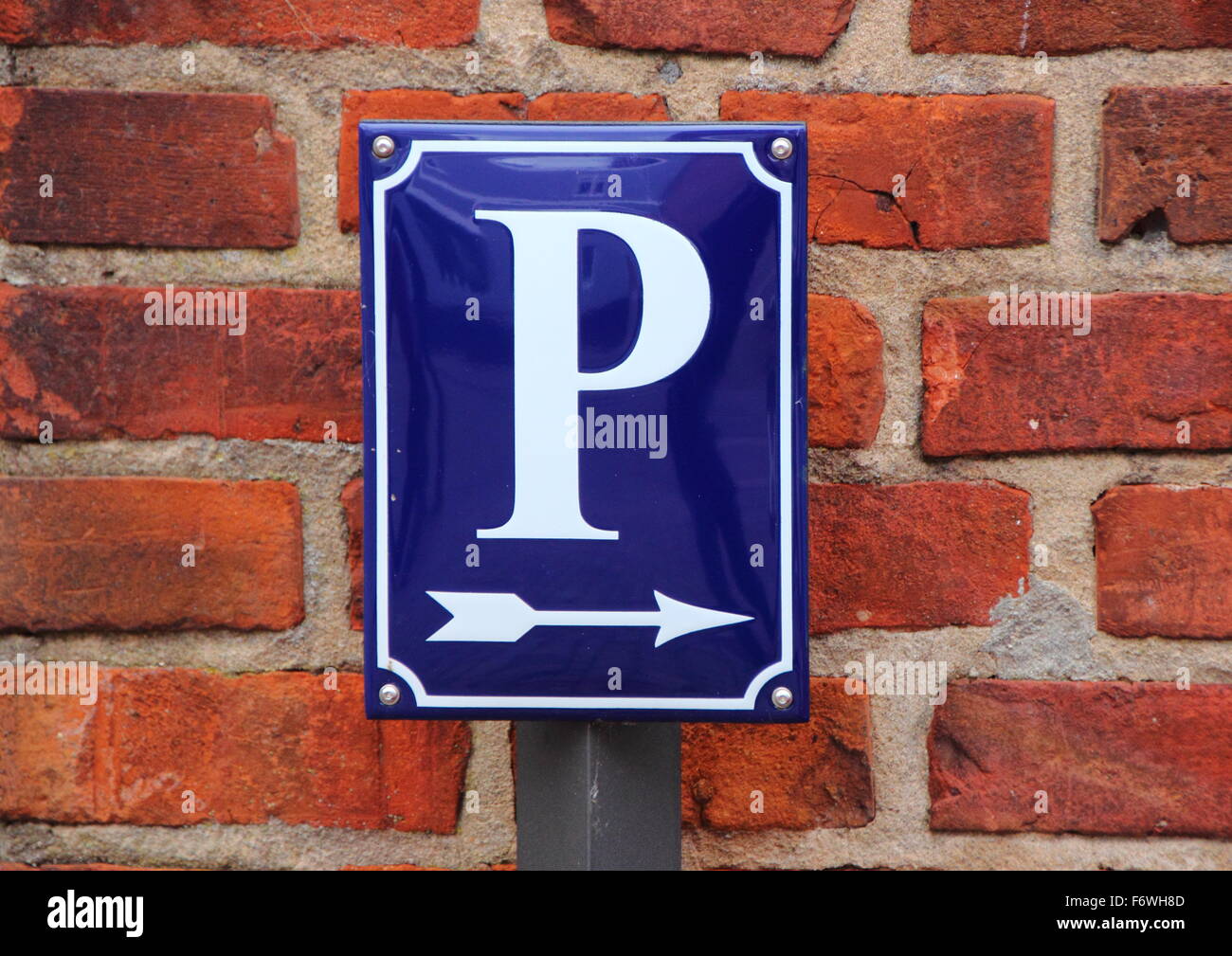 Enamel Parking Lot Sign with Arrow on Red Brick Tile Background Stock ...