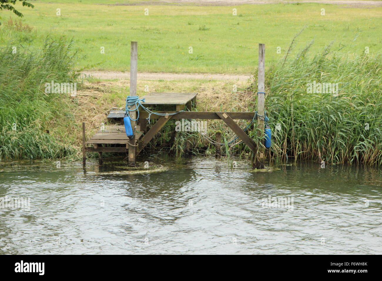Vacant Landing Stage Jetty at Small River with Reed Stock Photo - Alamy