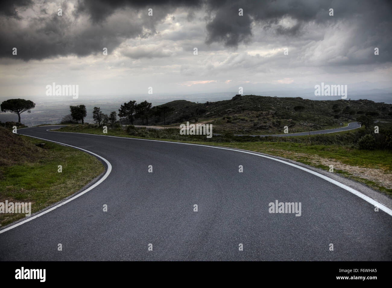 Bendy road in thunderstorm, Cap de Creus, Catalonia, Spain Stock Photo ...