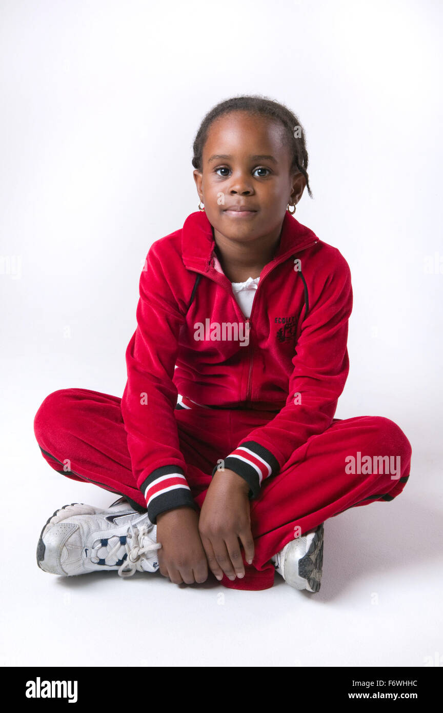 Young girl sitting on the floor crossed legged Stock Photo - Alamy