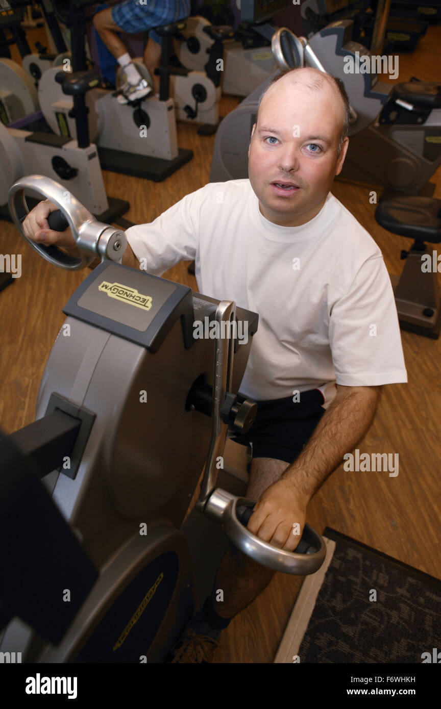 Access to services, Disabled man in the gym; using Ergometer Stock ...