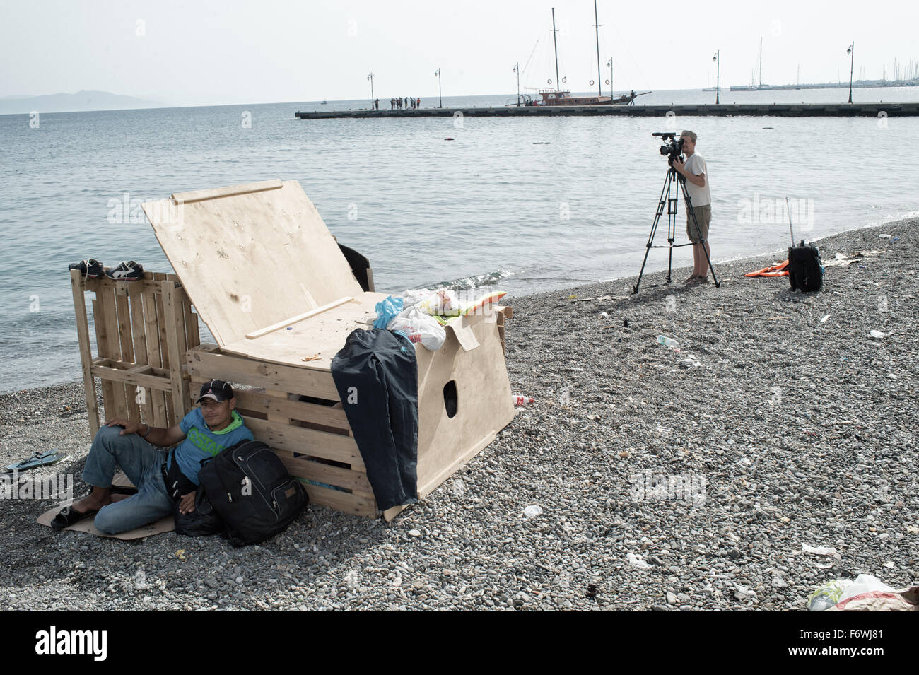 Syrian with an improvised house on the beach. A journlist is behing ...