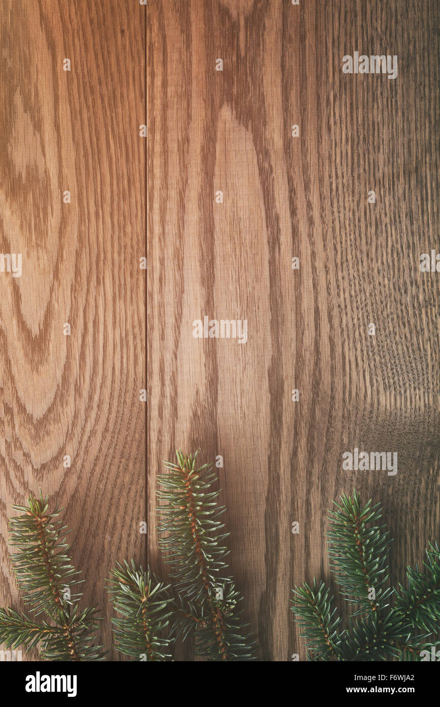vertical background with fir branch over oak table Stock Photo - Alamy