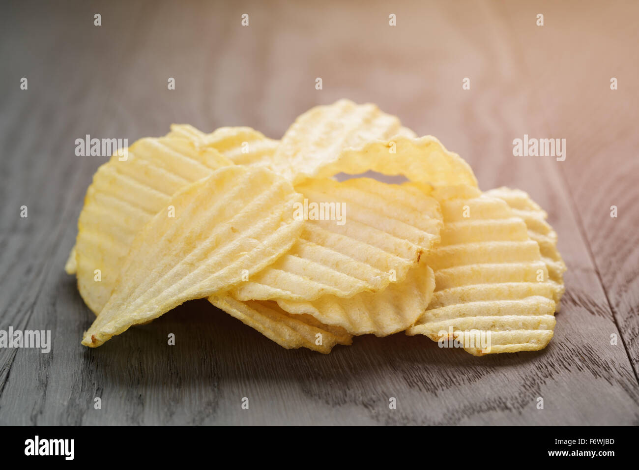 salted potato ships on old wooden table Stock Photo - Alamy