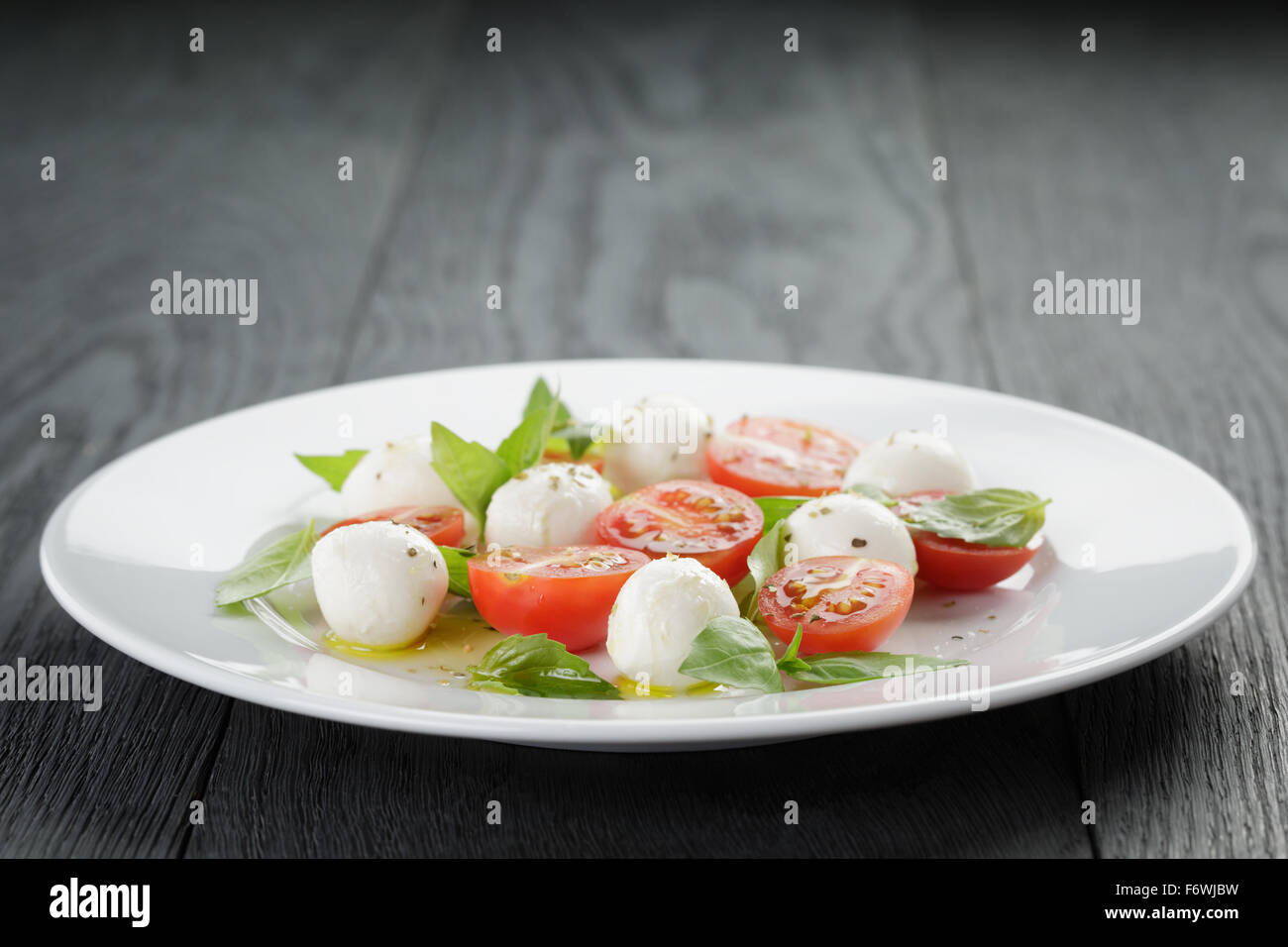 caprese salad with mini mozzarella balls and tomatoes Stock Photo - Alamy